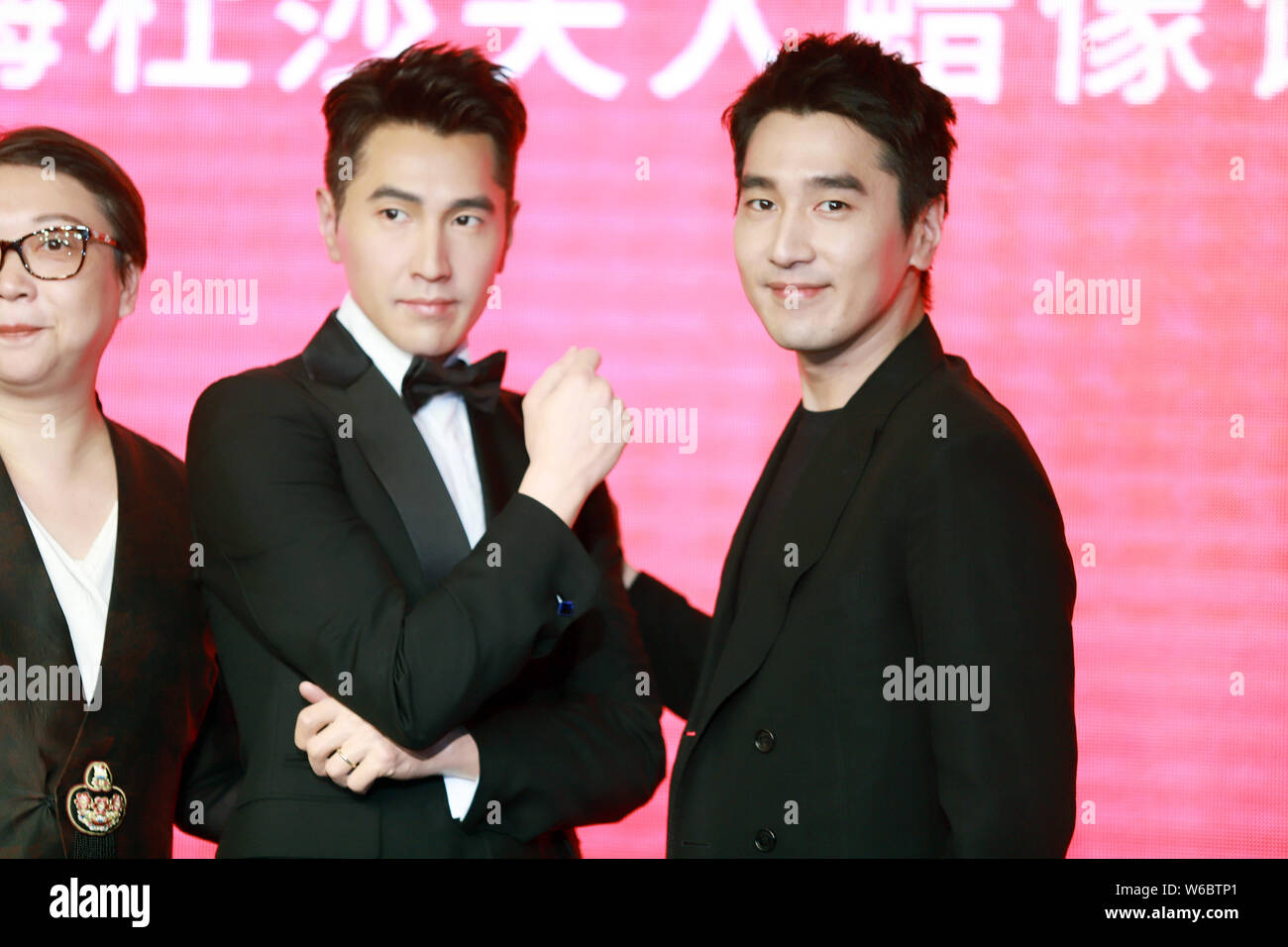 Taiwanese-Canadian actor Mark Chao, right, poses with a wax figure of ...