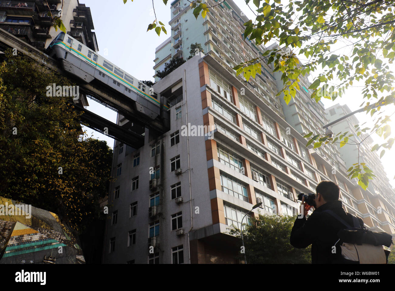 The No.2 light-rail train drives through a building in Liziba Station ...