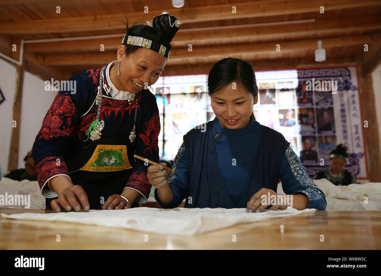 25-year-old Chinese woman Zhang Yiping of Miao ethnic group teaches a ...