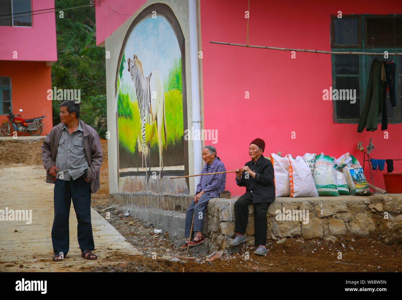 Villagers are pictured with the colorful fairy tale houses of the ...