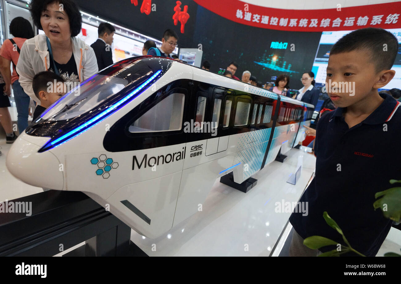 Vistiors look at a new driverless carbon-fiber monorail train ...