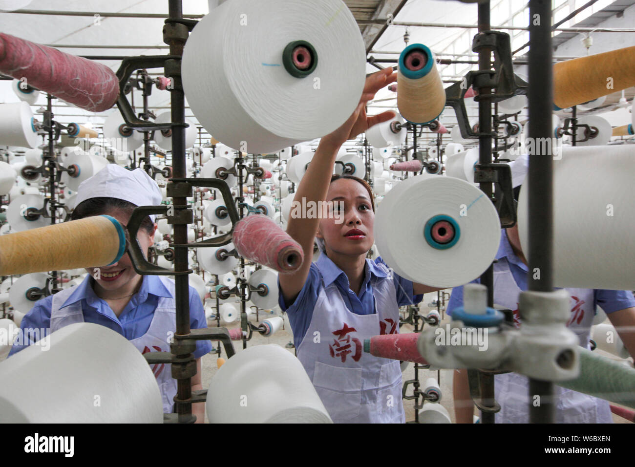 --FILE--A female Chinese worker handles production of yarn at a textile factory in Nanping city ...