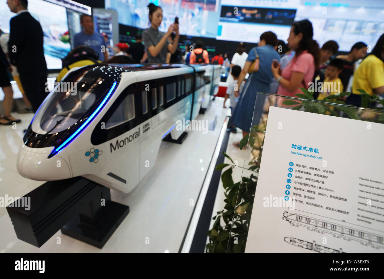 Vistiors look at a new driverless carbon-fiber monorail train ...