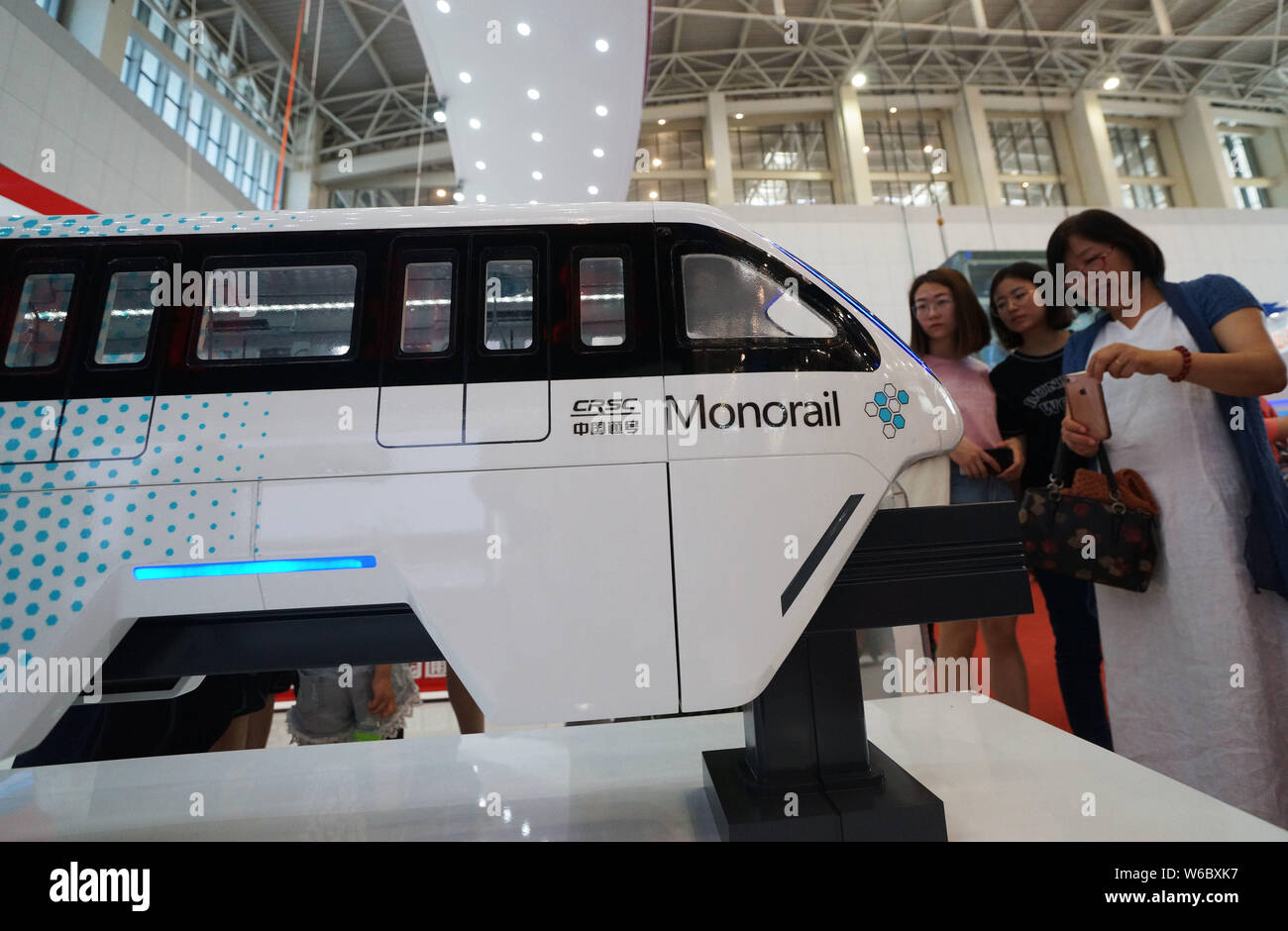 Vistiors look at a new driverless carbon-fiber monorail train ...