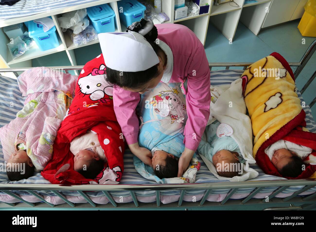 --FILE--A Chinese nurse attends newborn babies at a hospital in ...