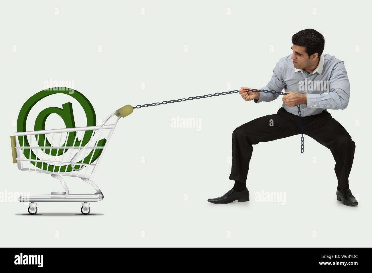 Man hauling at symbol in a shopping cart Stock Photo - Alamy