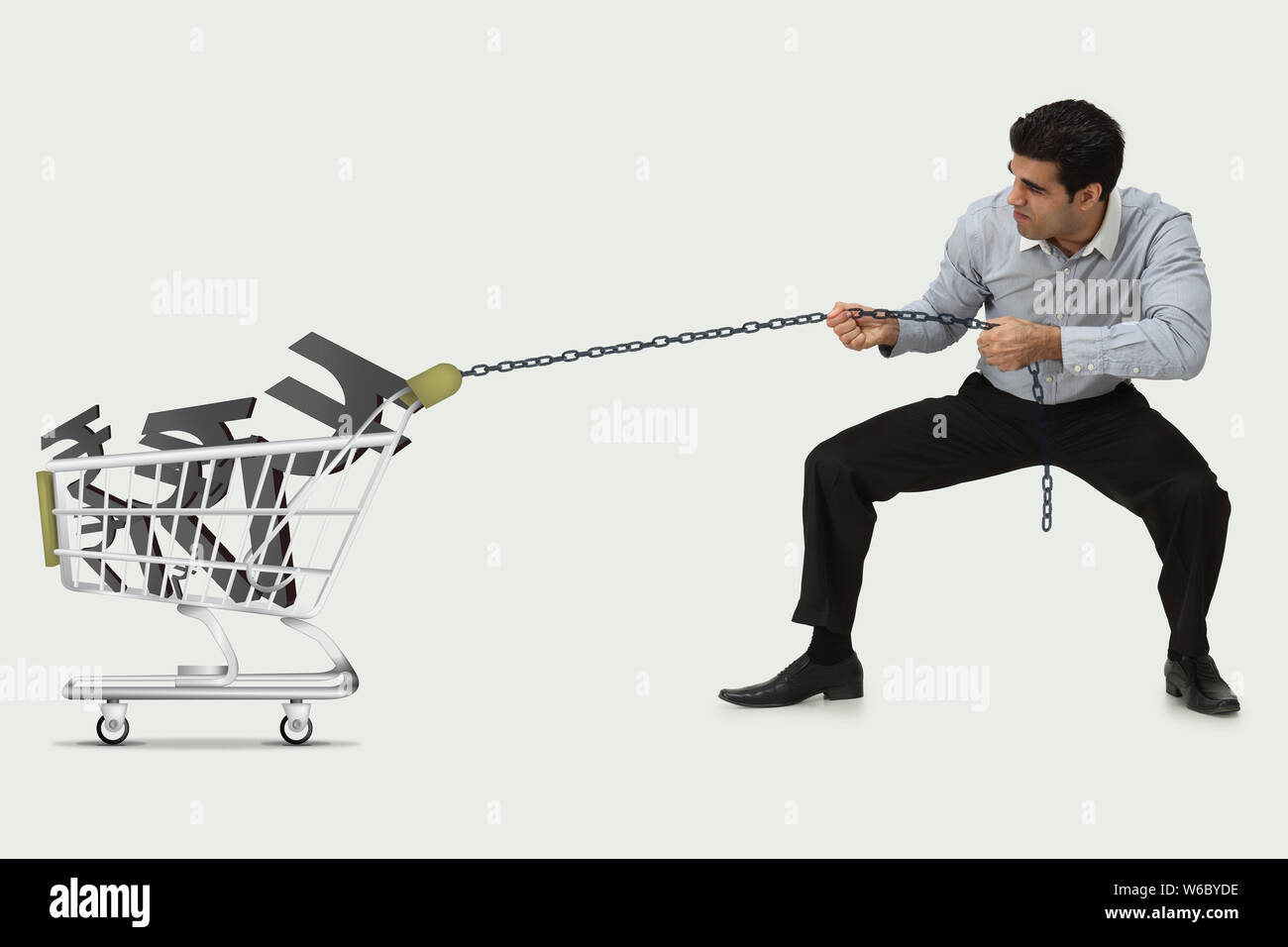 Man hauling rupee symbols in a shopping cart Stock Photo - Alamy