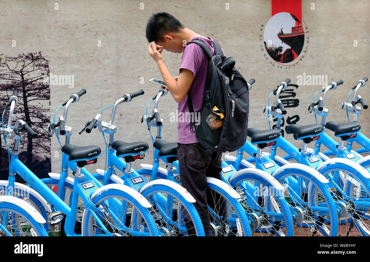 --FILE--A local resident uses his smartphone to scan the QR code on a ...