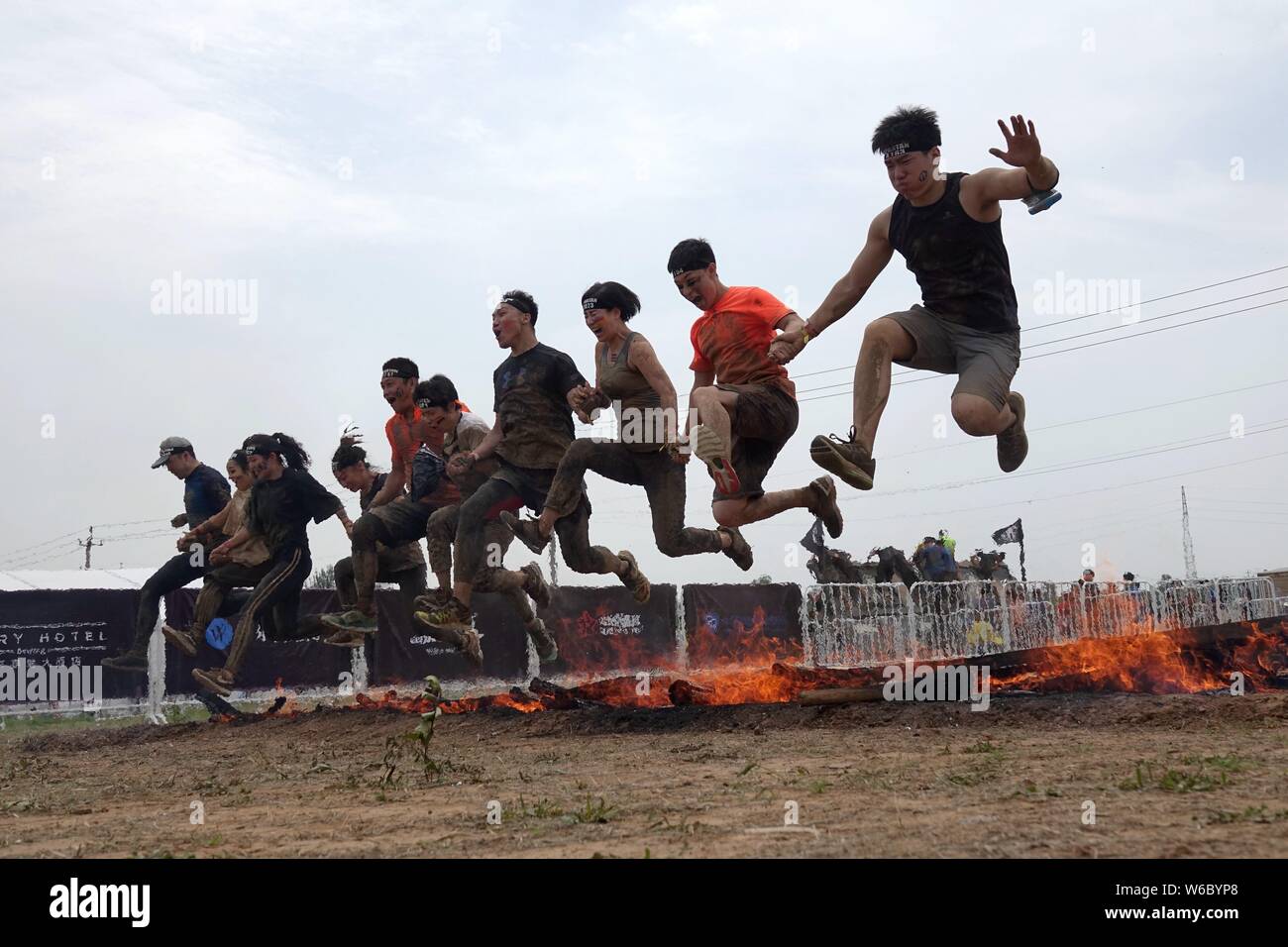 Participants compete in the 2018 INFINITI Spartan Race obstacle course ...