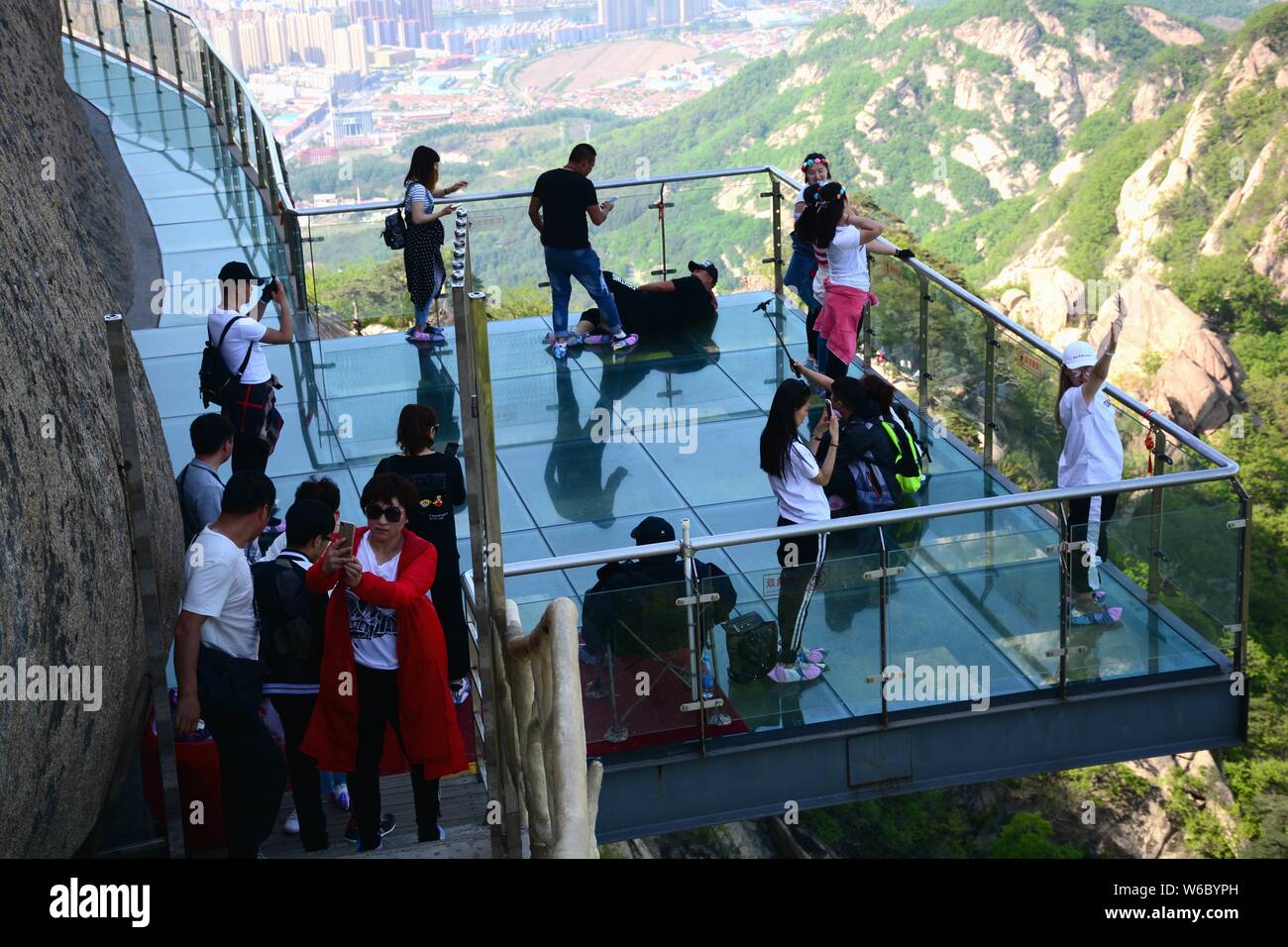 Tourists pose for photos on the 30-square-meter sightseeing platform ...