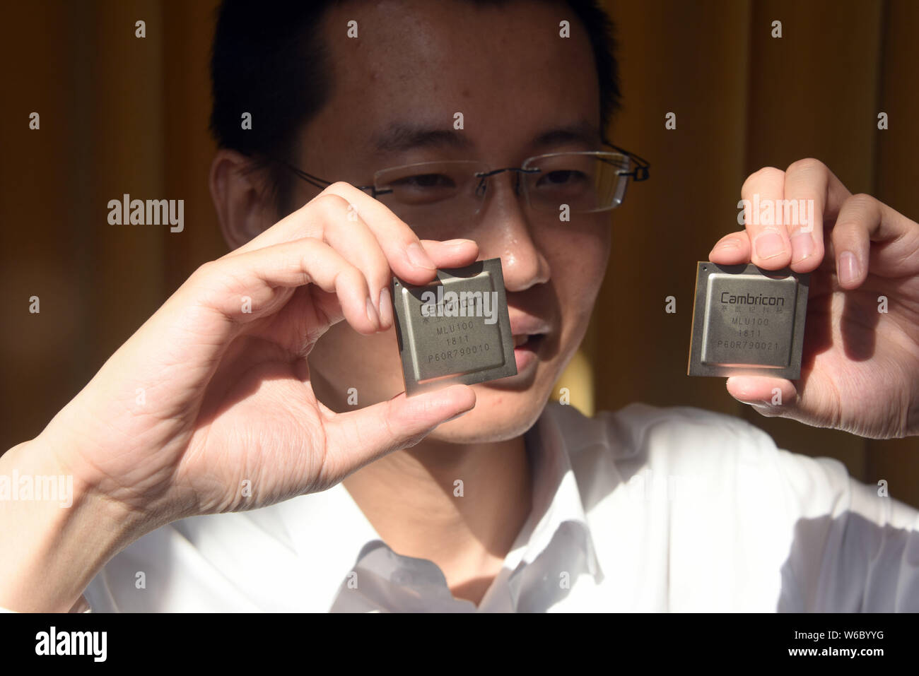 Cambricon Technology CEO Chen Tianshi shows a pair of Cambricon MLU100 ...