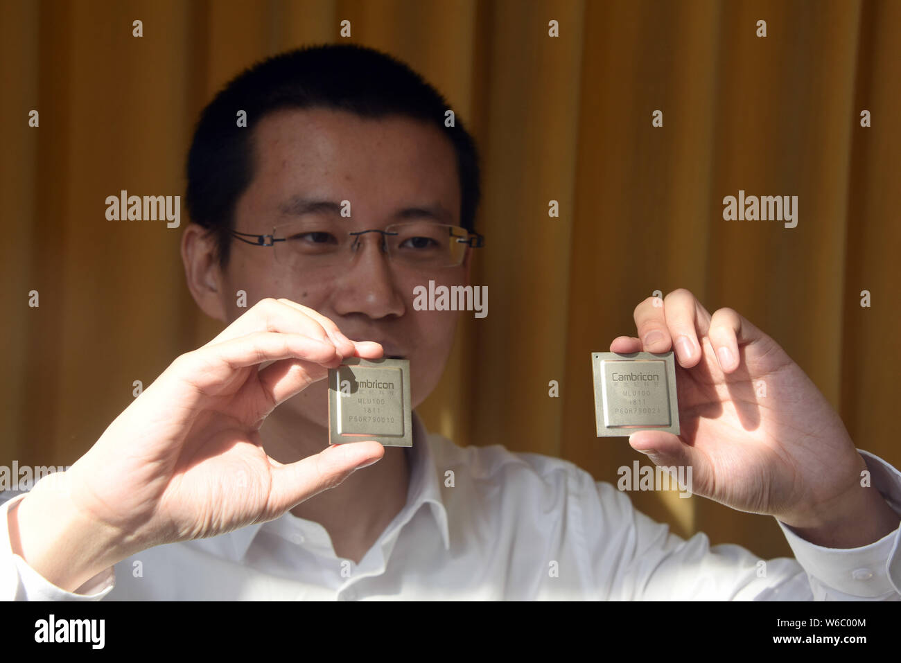 Cambricon Technology CEO Chen Tianshi shows a pair of Cambricon MLU100 ...