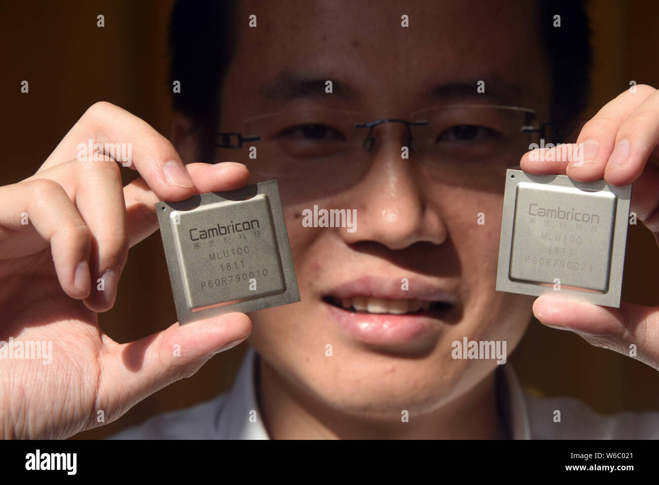 Cambricon Technology CEO Chen Tianshi shows a pair of Cambricon MLU100 ...