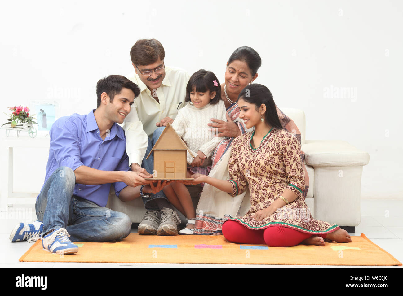 Family with model of dream home Stock Photo - Alamy