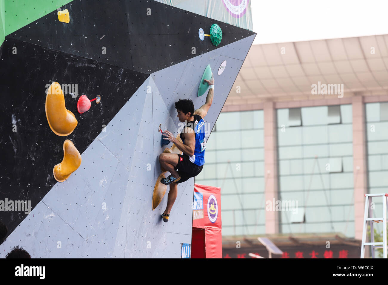 Rei Sugimoto of Japan competes in the men bouldering qualification ...