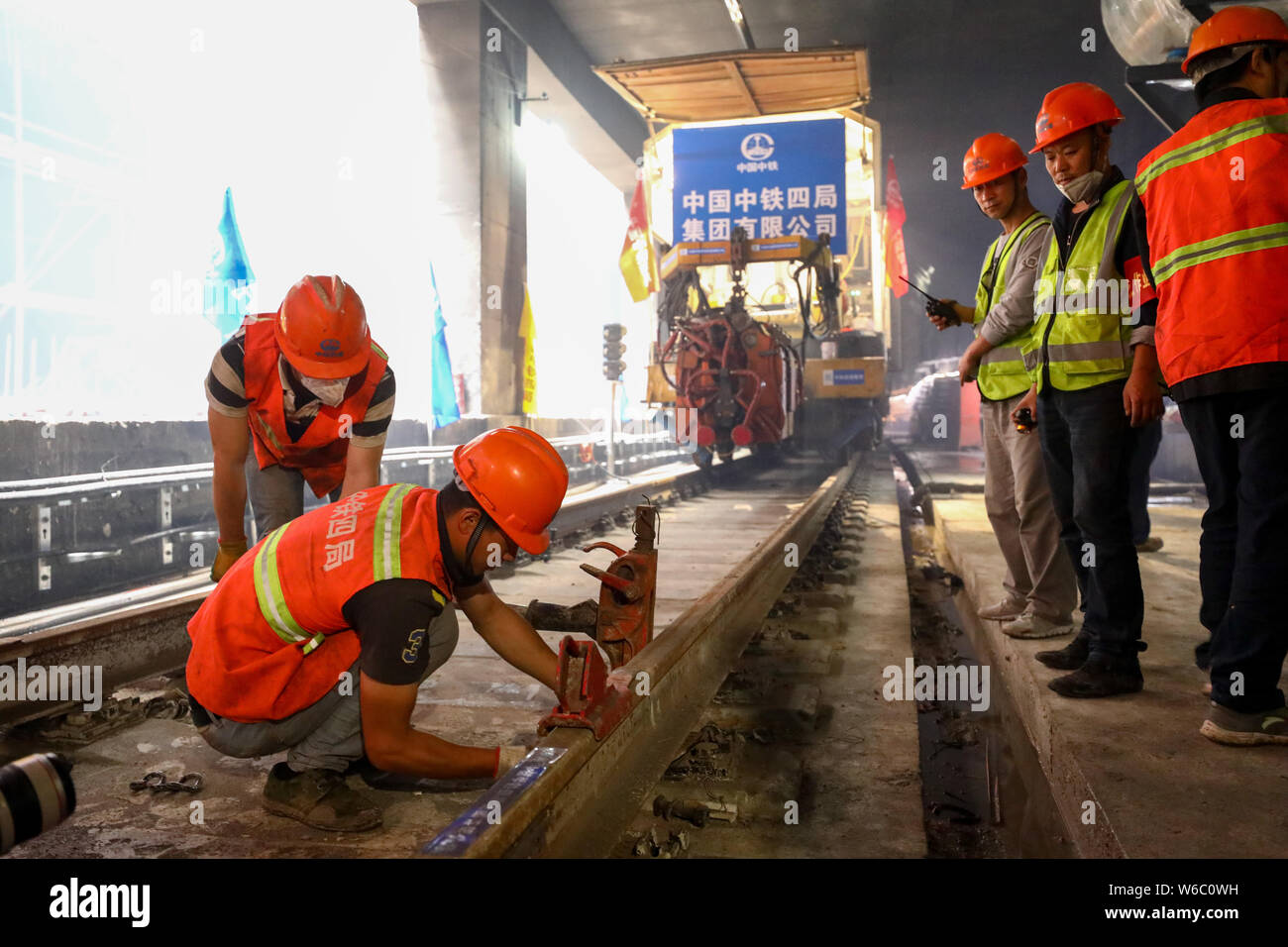 Chinese workers labor at the track construction site of the second and ...