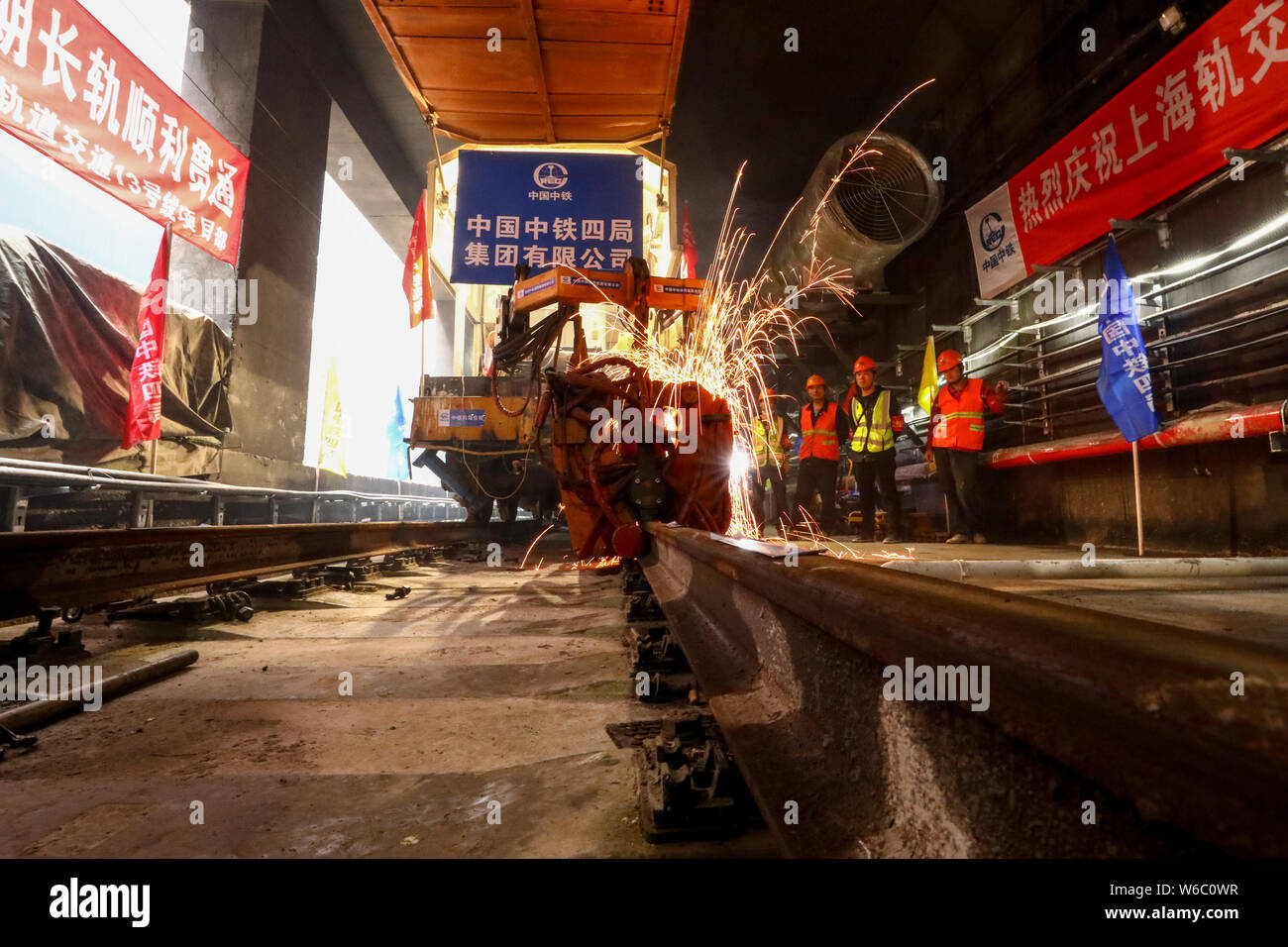 Chinese workers labor at the track construction site of the second and ...