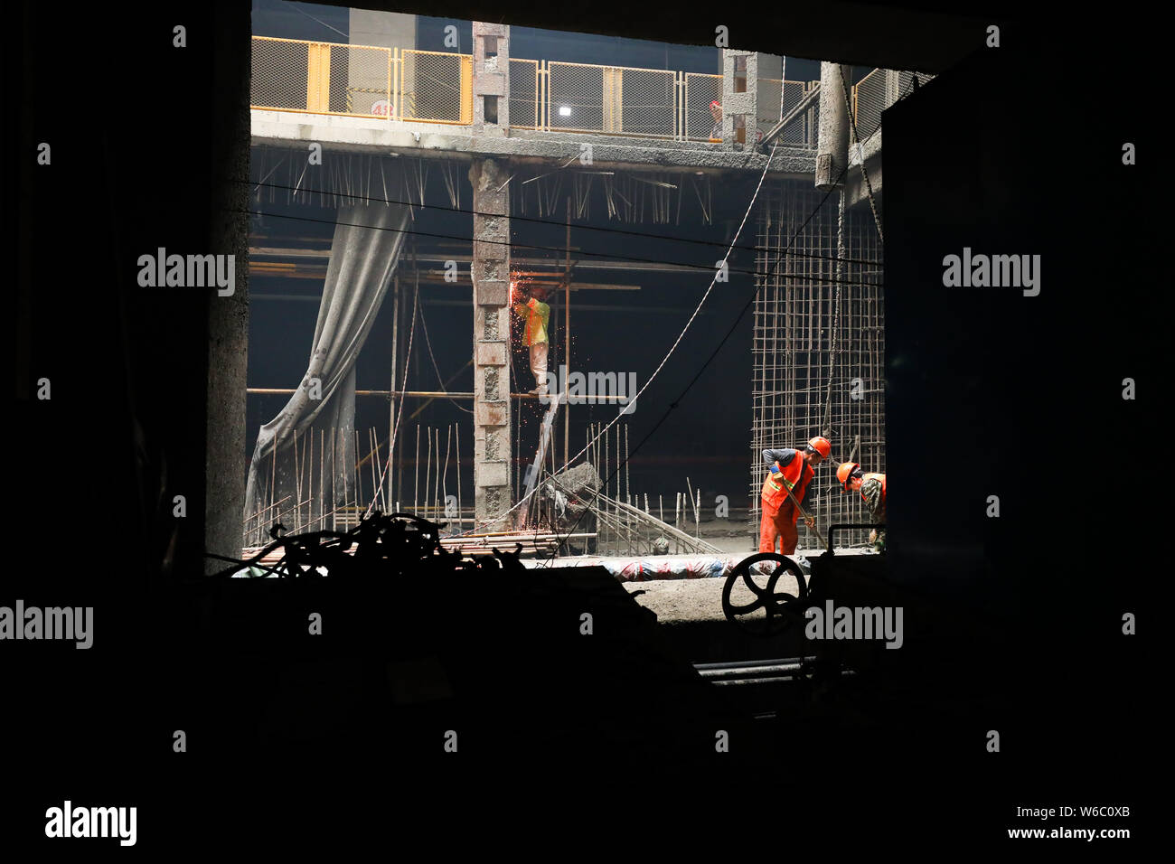 Chinese workers labor at the track construction site of the second and ...