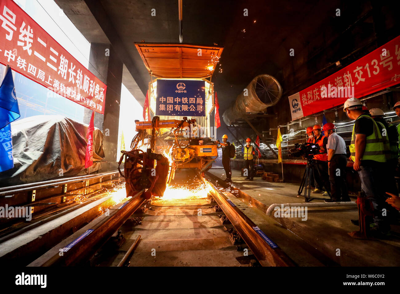 Chinese workers labor at the track construction site of the second and ...