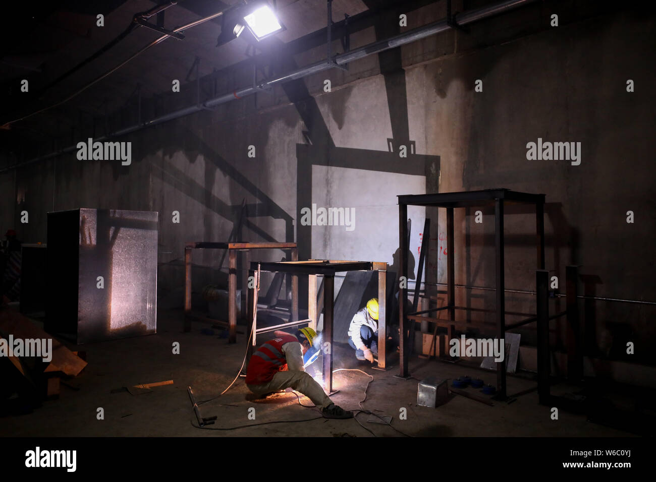Chinese workers labor at the track construction site of the second and ...