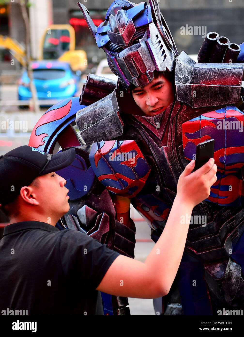 FILE 25 year old Chinese man Liu Sen tries out a realistic costume of Optimus Prime from Hollywood movie Transformers Age of Extinction at his w Stock Photo Alamy