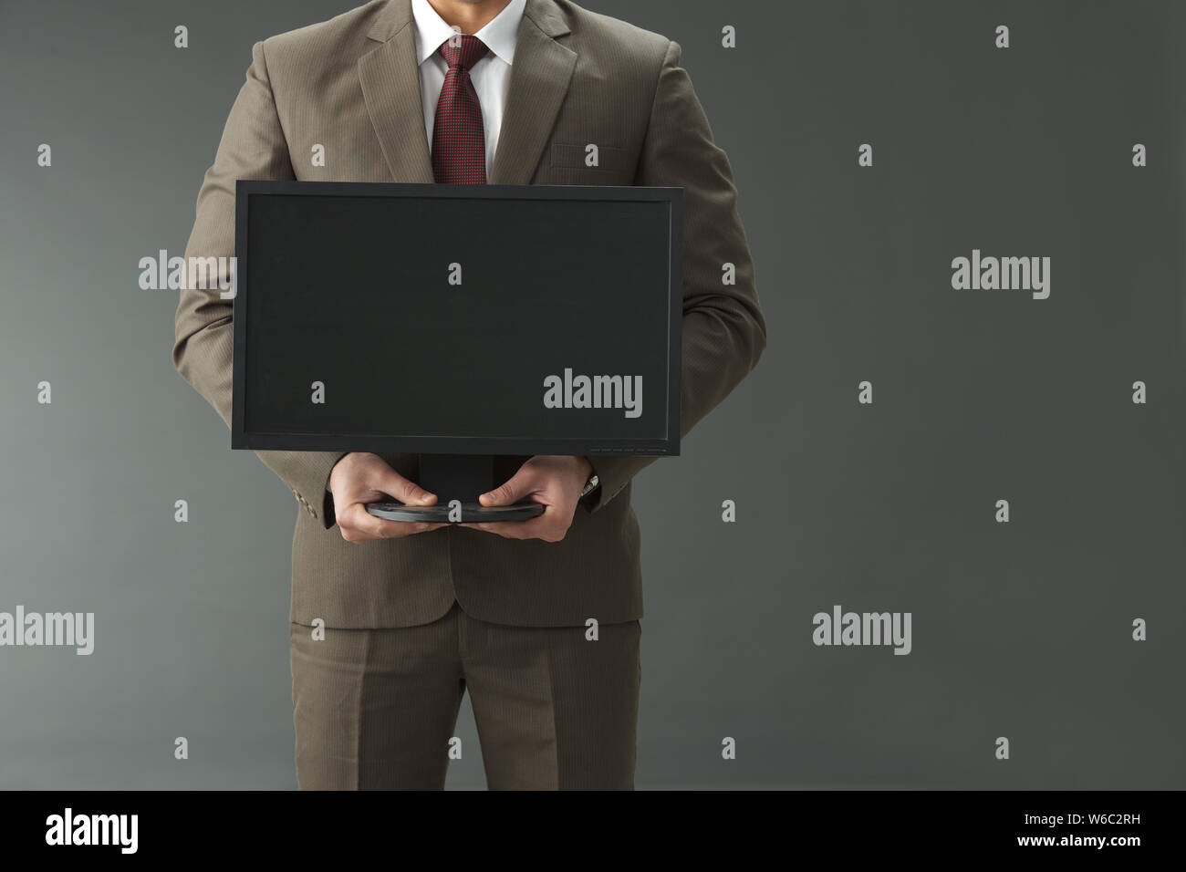 Businessman showing PC Monitor Stock Photo - Alamy