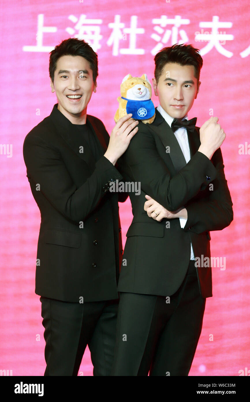Taiwanese-Canadian actor Mark Chao, left, poses with a wax figure of ...