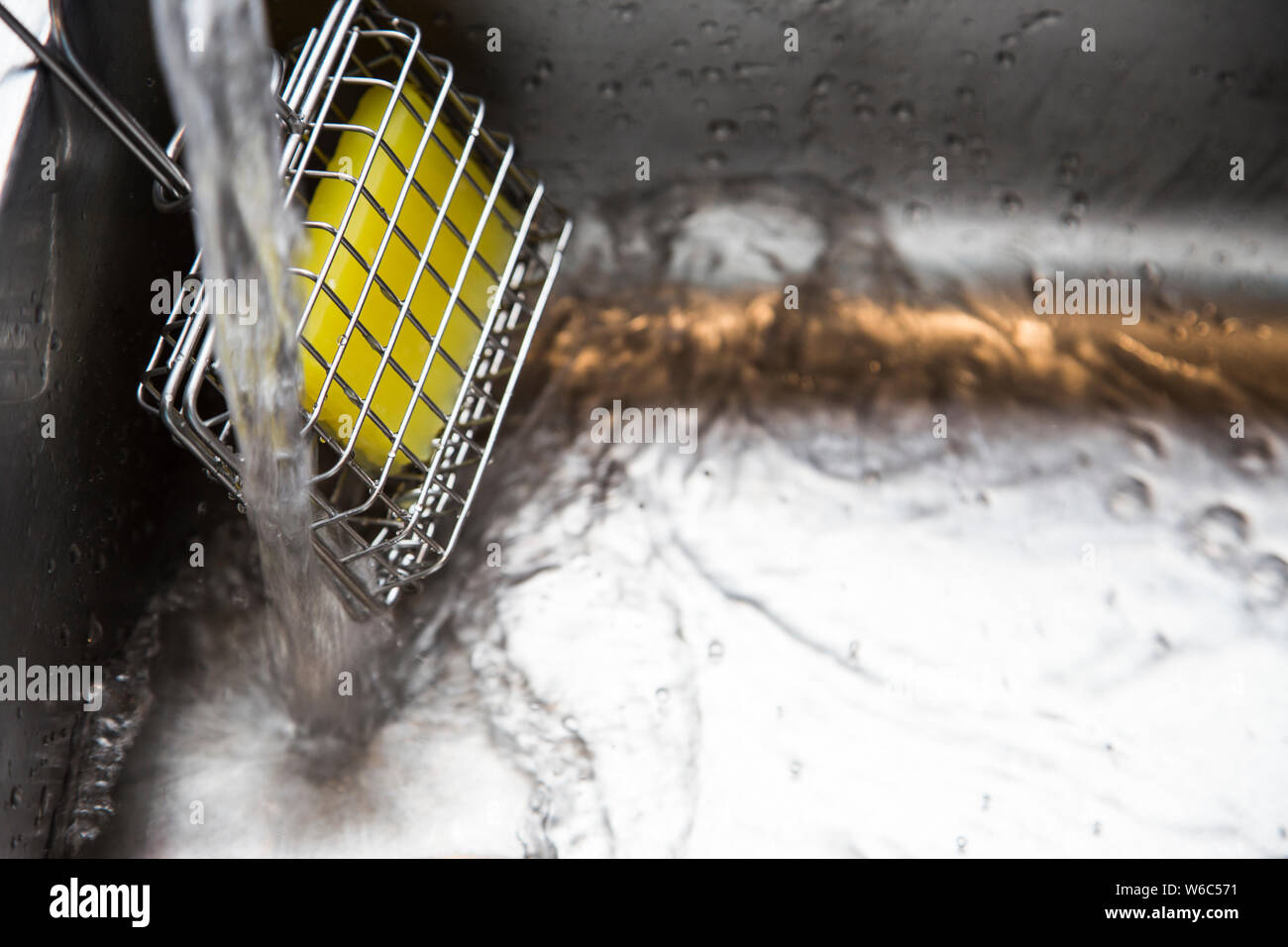 Soap shaker in use in the kitchen. Used to create soapy water to wash ...