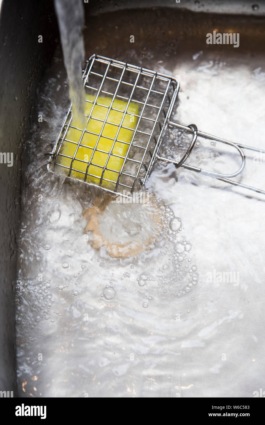Soap shaker in use in the kitchen. Used to create soapy water to wash ...