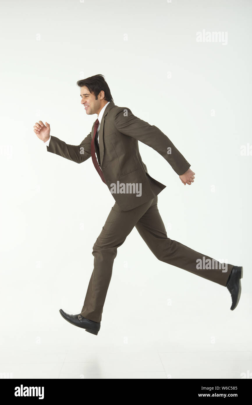Young happy man running suit hi-res stock photography and images - Alamy