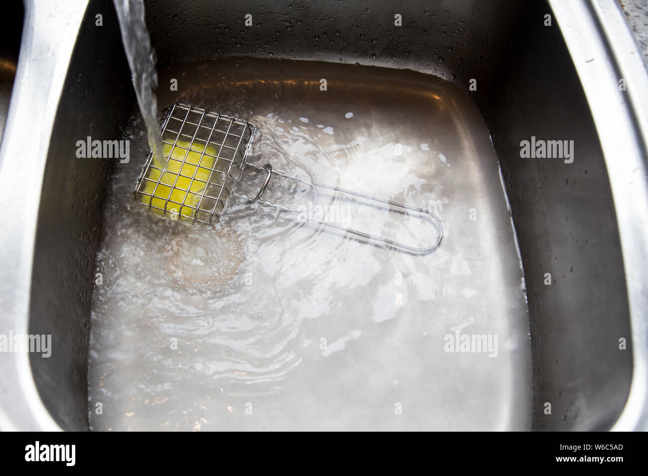 Soap shaker in use in the kitchen. Used to create soapy water to wash ...