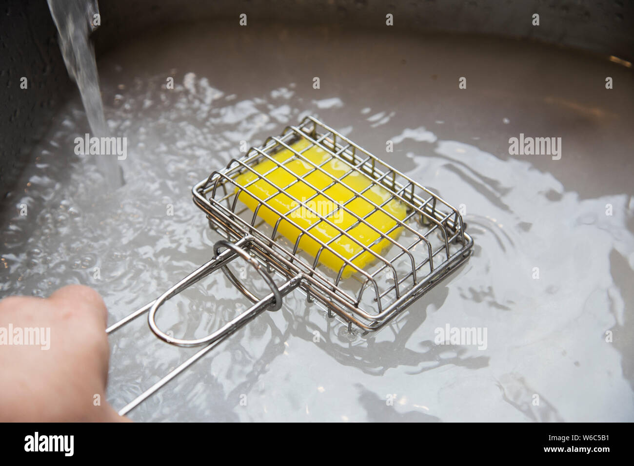 Soap shaker in use in the kitchen. Used to create soapy water to wash ...