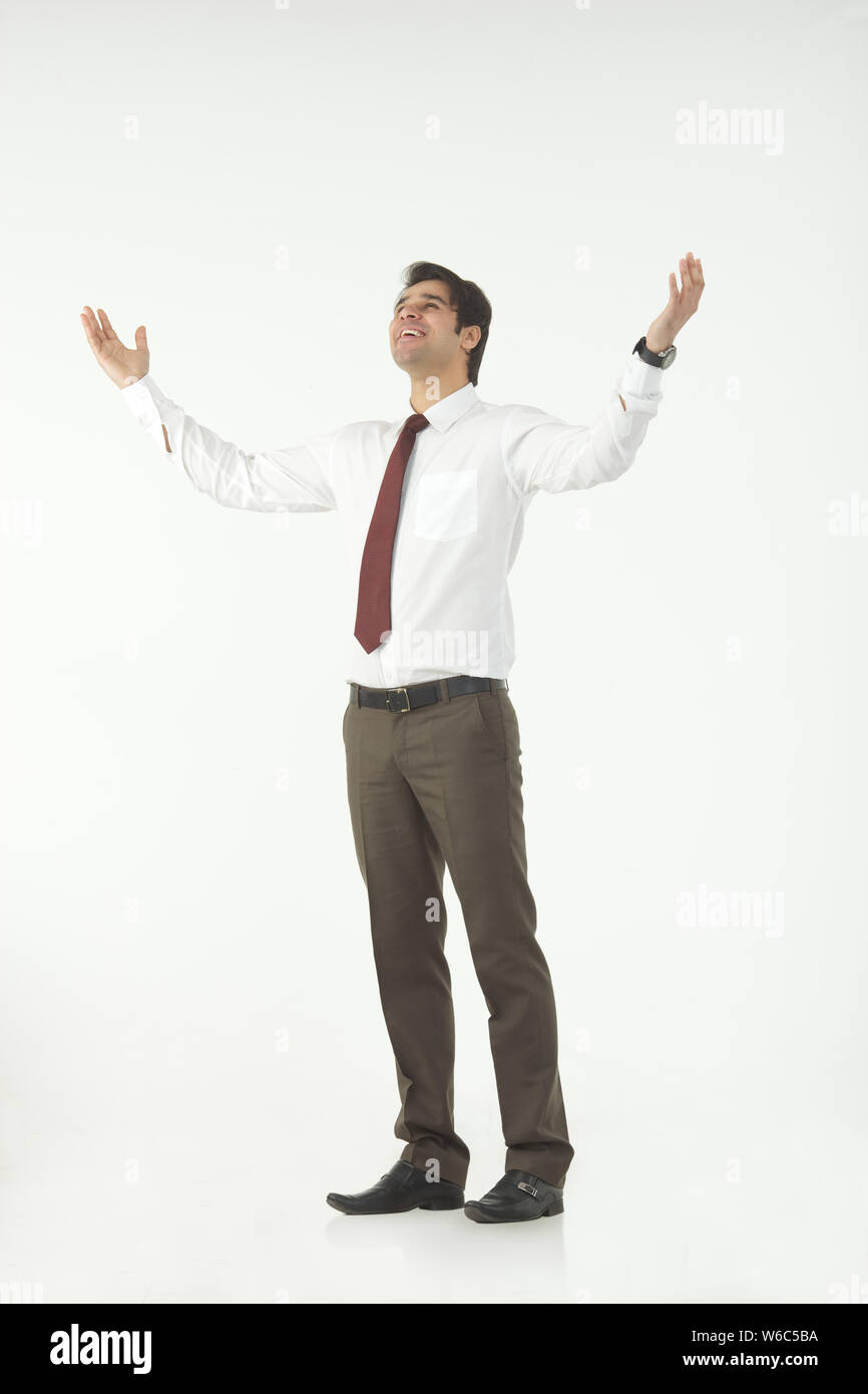 Businessman standing with his arm outstretched Stock Photo - Alamy