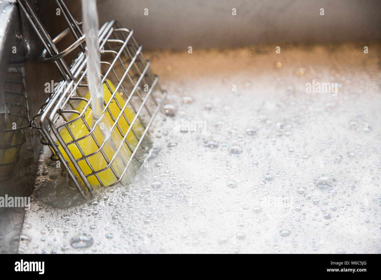Soap shaker in use in the kitchen. Used to create soapy water to wash ...