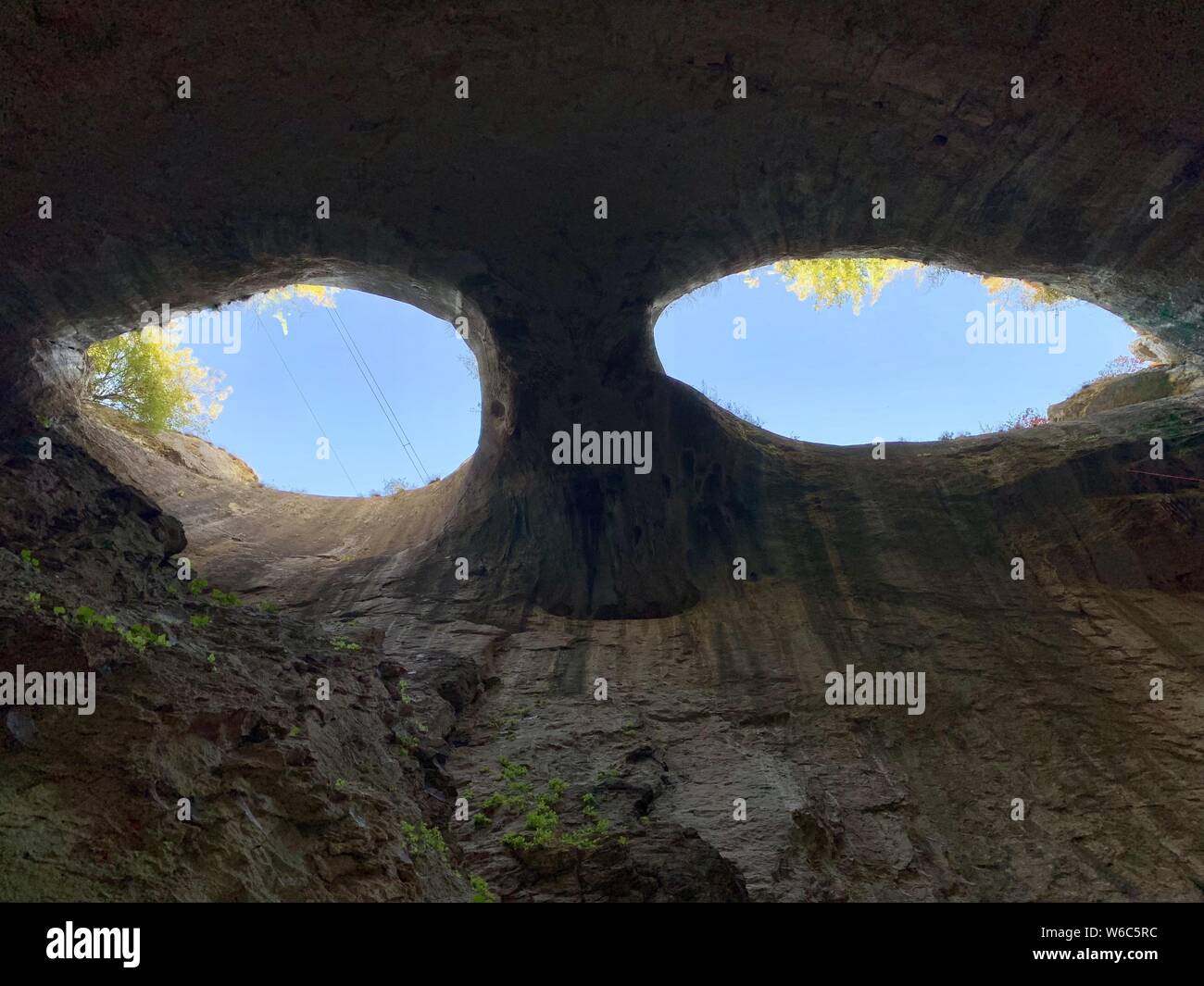 Upshot from a cave of two cave holes in a shape of eyes Stock Photo - Alamy