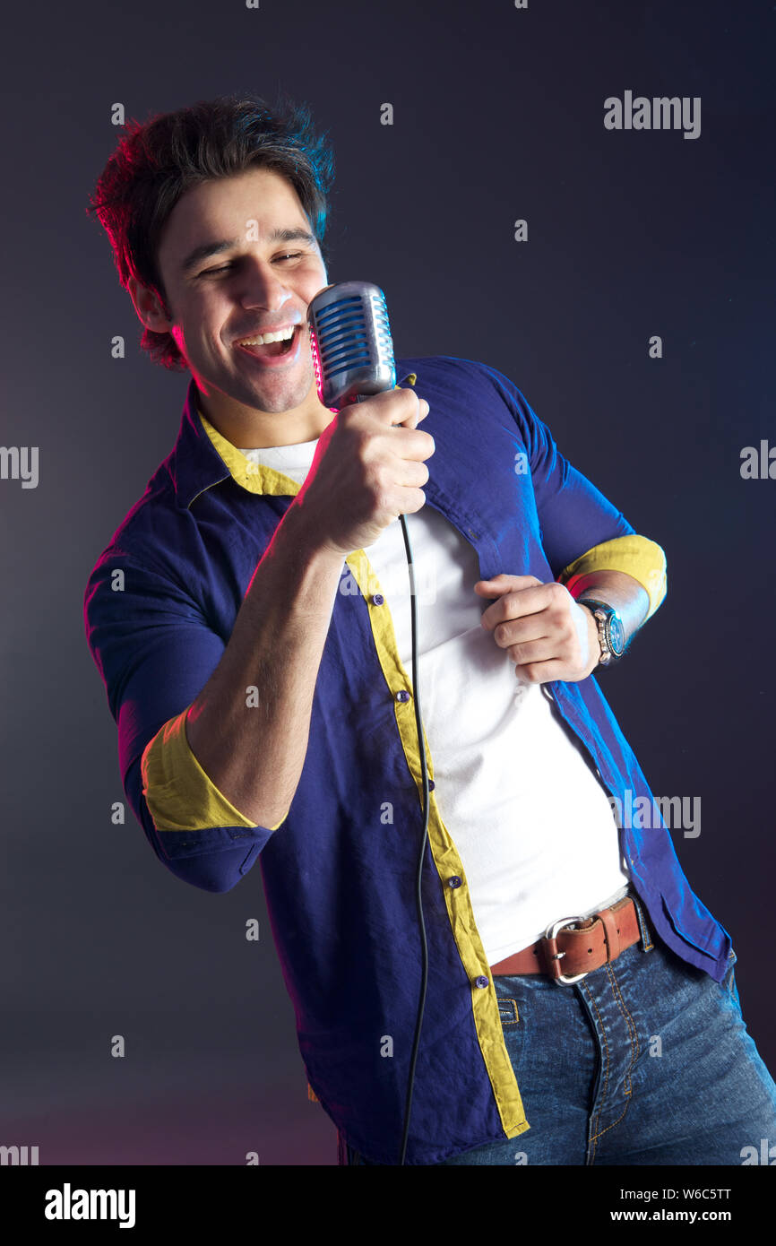 Indian man singing microphone smiling hi-res stock photography and ...