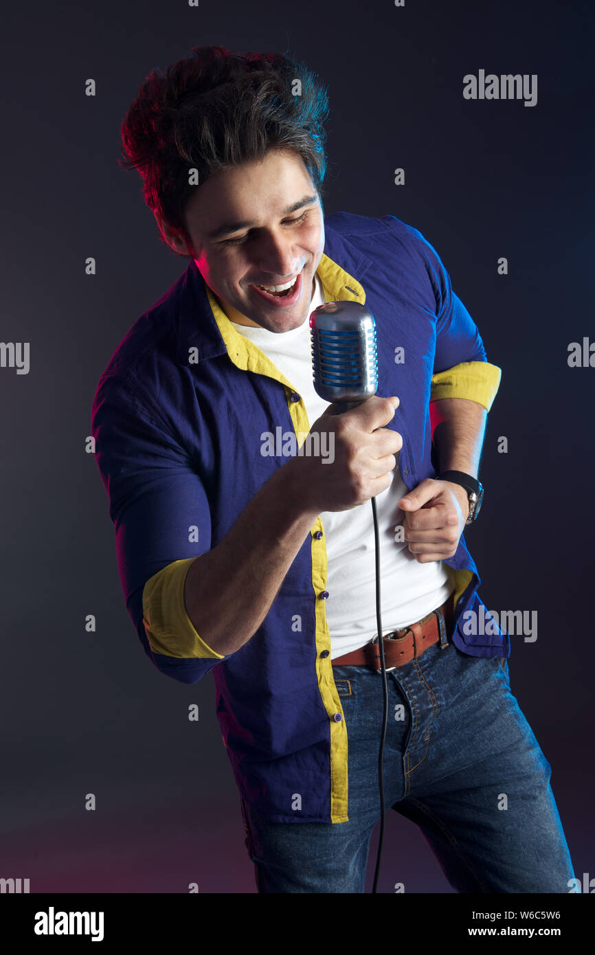 Indian man singing microphone smiling hi-res stock photography and ...