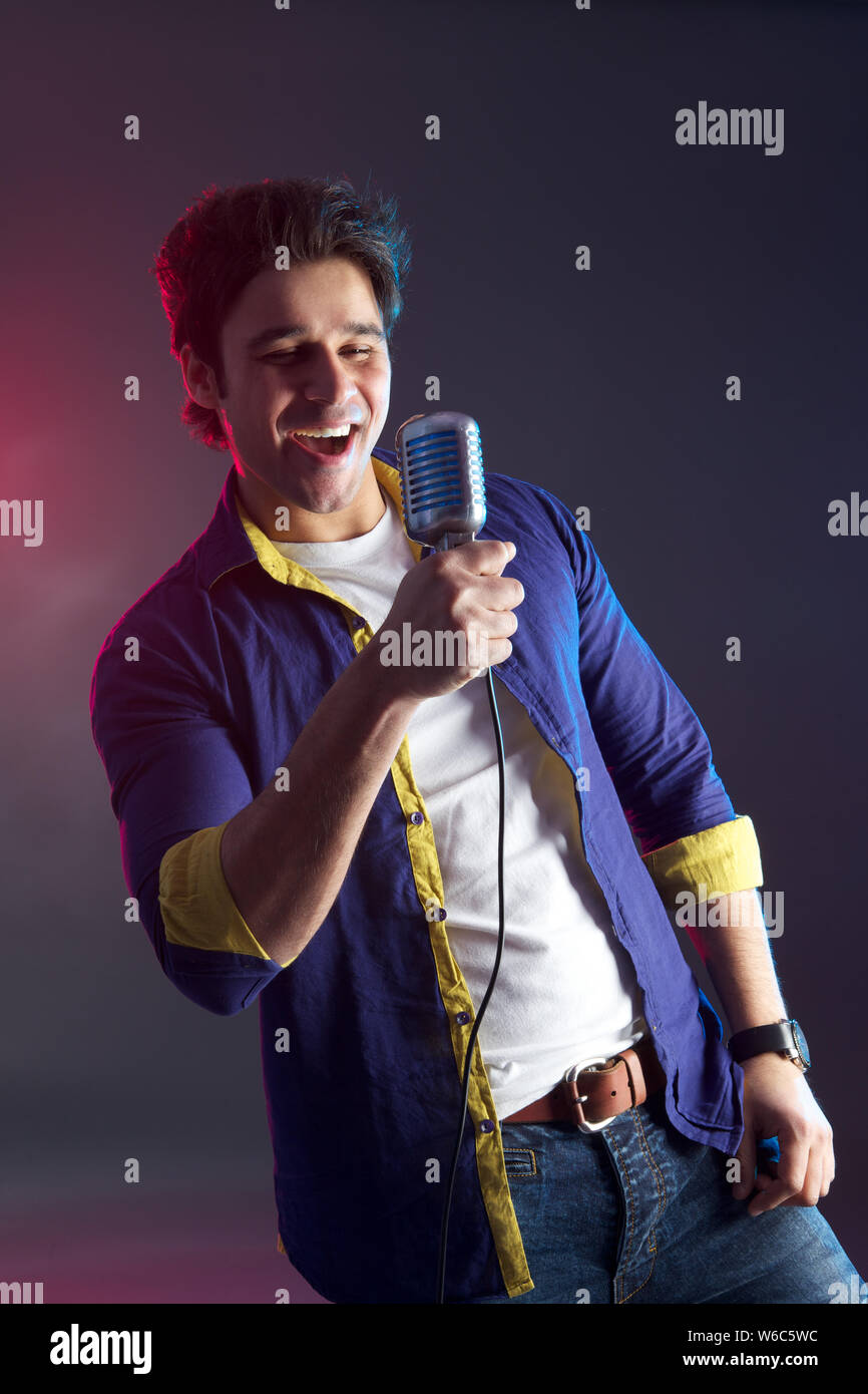 Indian man singing microphone smiling hi-res stock photography and ...