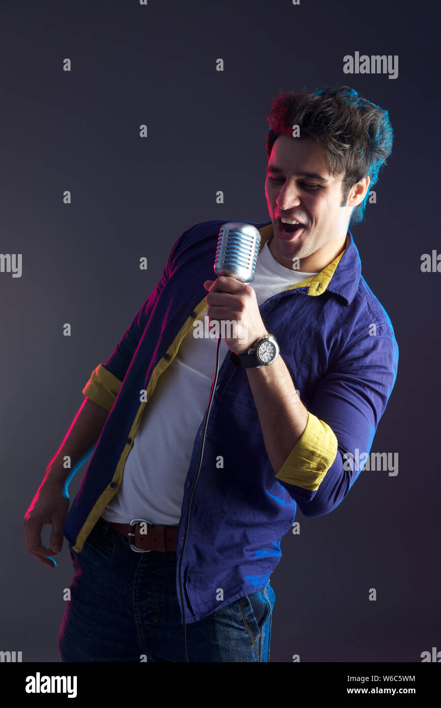Indian man singing microphone smiling hi-res stock photography and ...