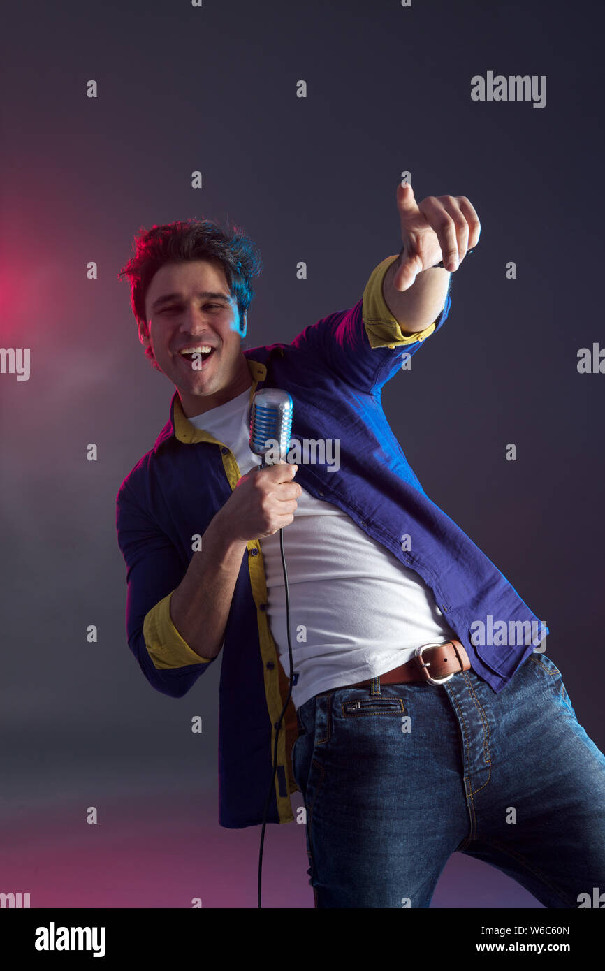 Man singing into microphone Stock Photo - Alamy