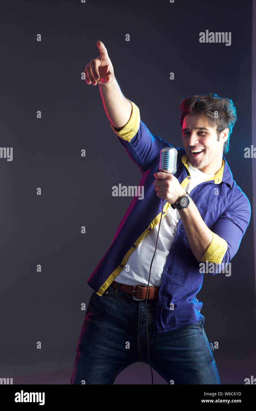 Man singing into microphone Stock Photo - Alamy