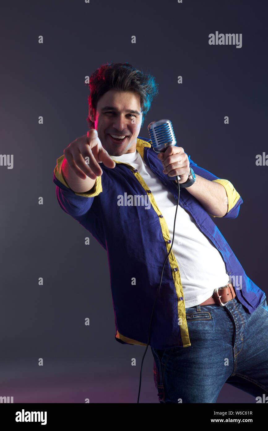 Man singing into microphone Stock Photo - Alamy