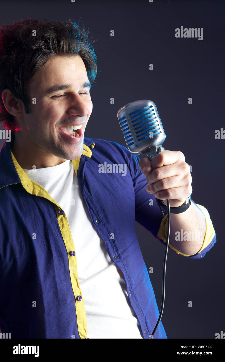 Man singing into microphone Stock Photo - Alamy