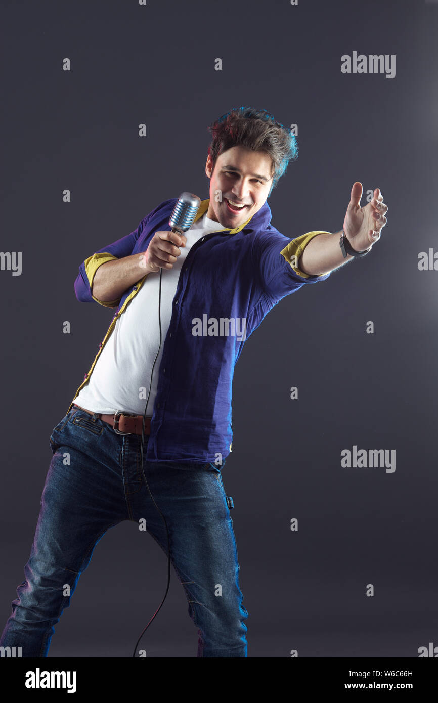 Man singing into microphone Stock Photo - Alamy