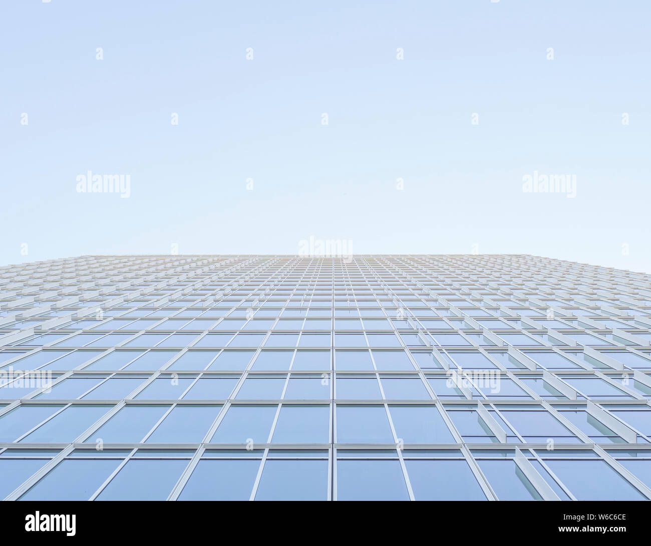 A view from the ground up to a skyscraper merging into the sky, simple ...