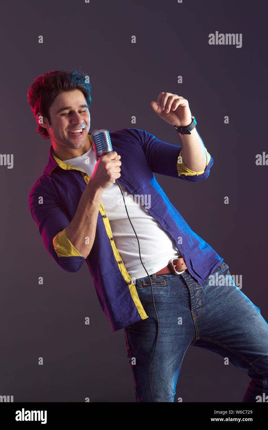 Man singing into microphone Stock Photo - Alamy