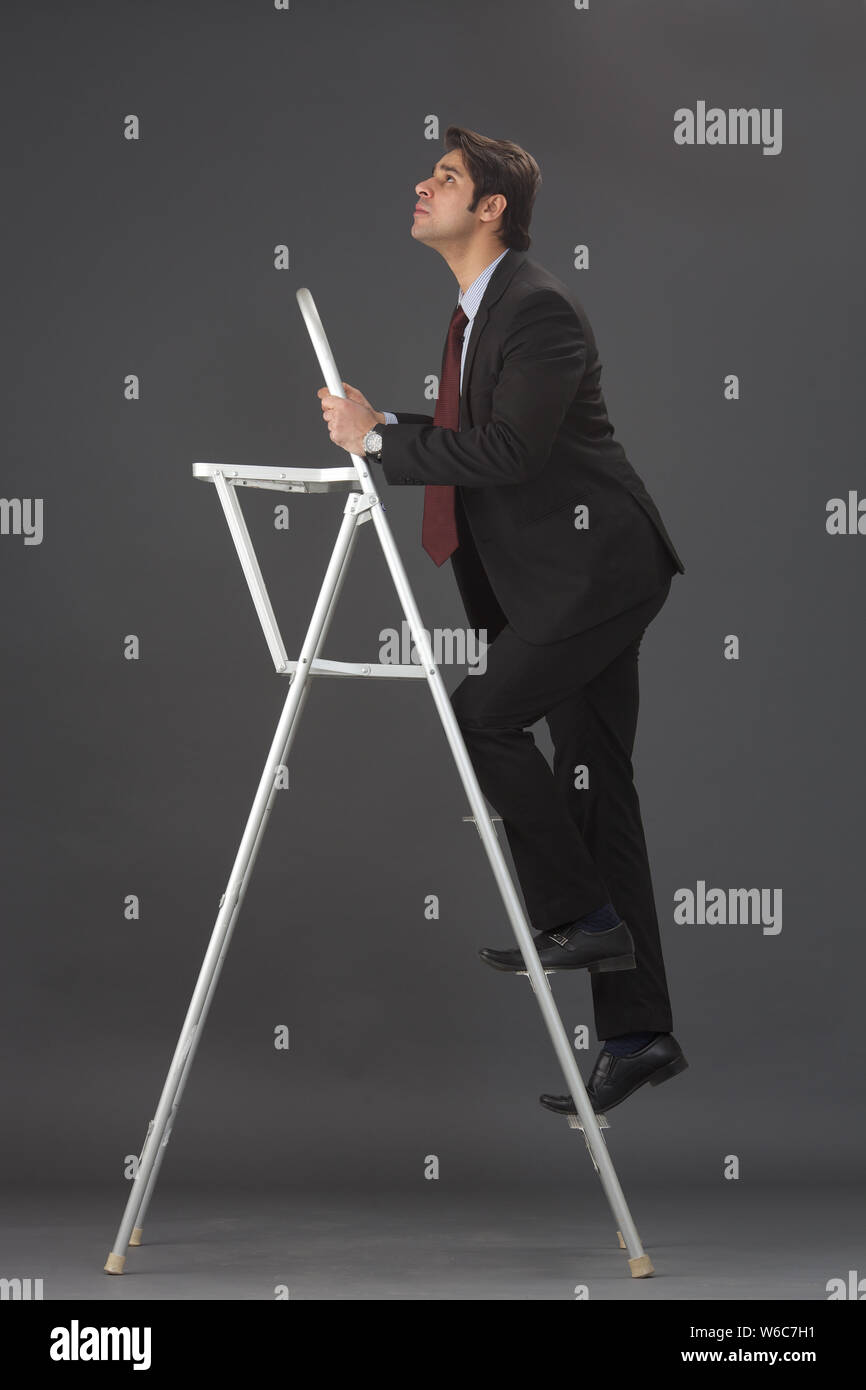 Man climbing step ladder hi-res stock photography and images - Alamy