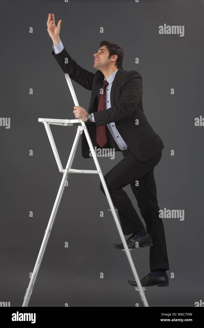 Man climbing step ladder hi-res stock photography and images - Alamy