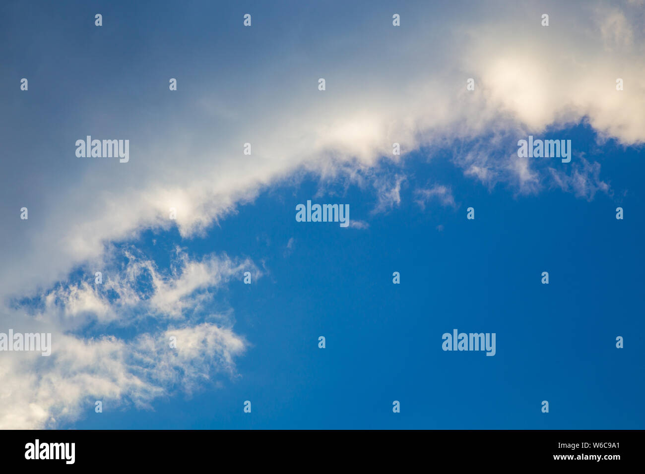 blue sky with clouds backlit by the soft rays of the sun Stock Photo ...