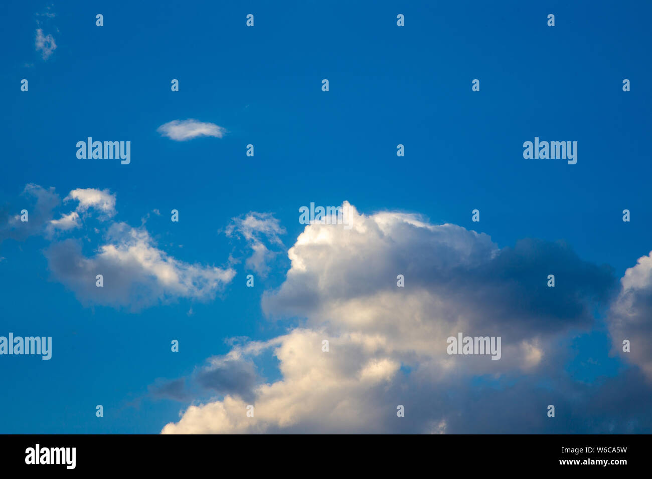 blue sky with clouds backlit by the soft rays of the sun Stock Photo ...